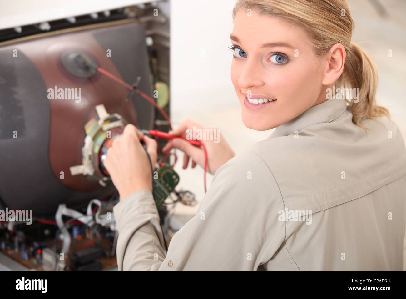 Woman repairing machine Stock Photo - Alamy