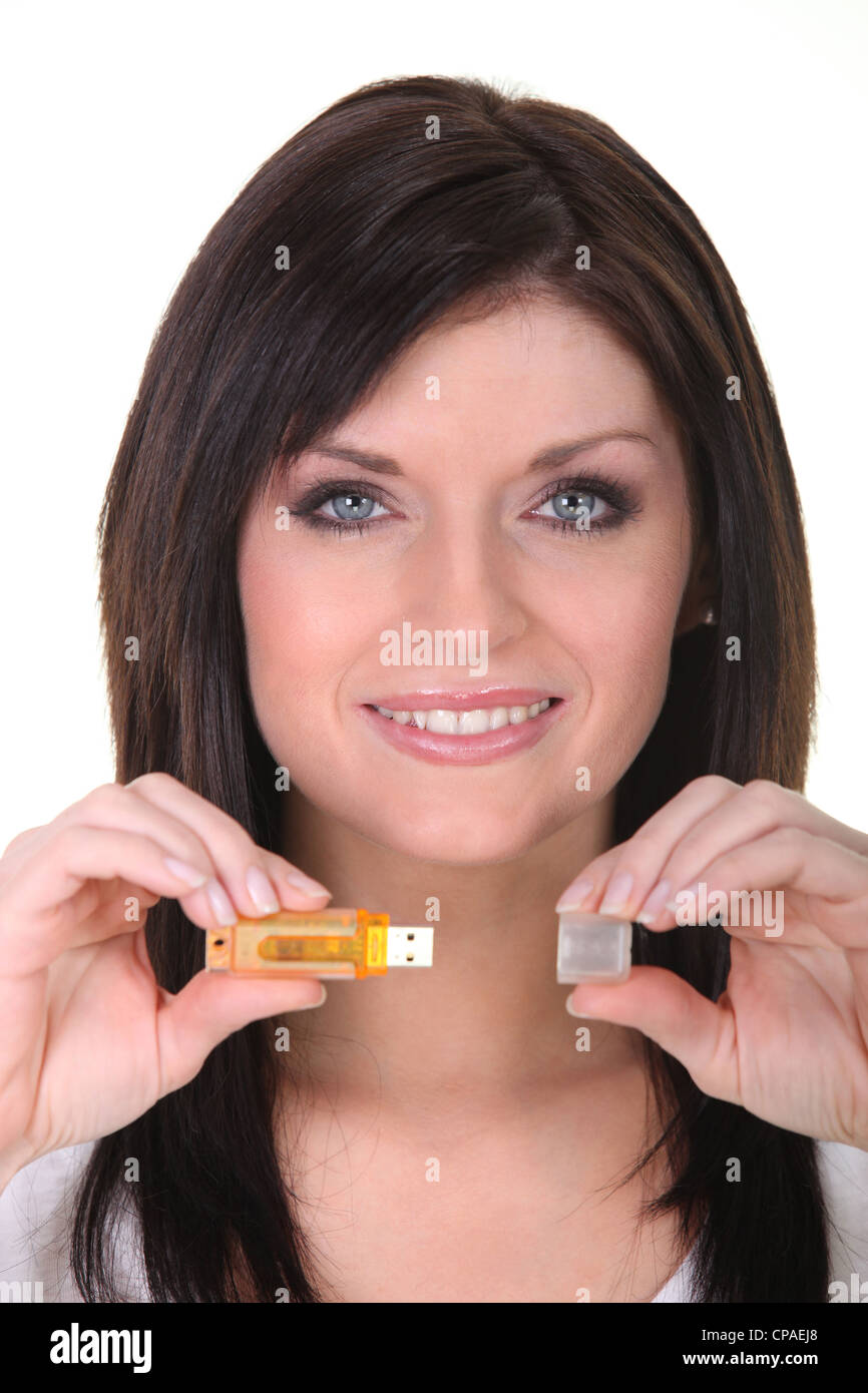 Attractive woman showing USB key Stock Photo - Alamy