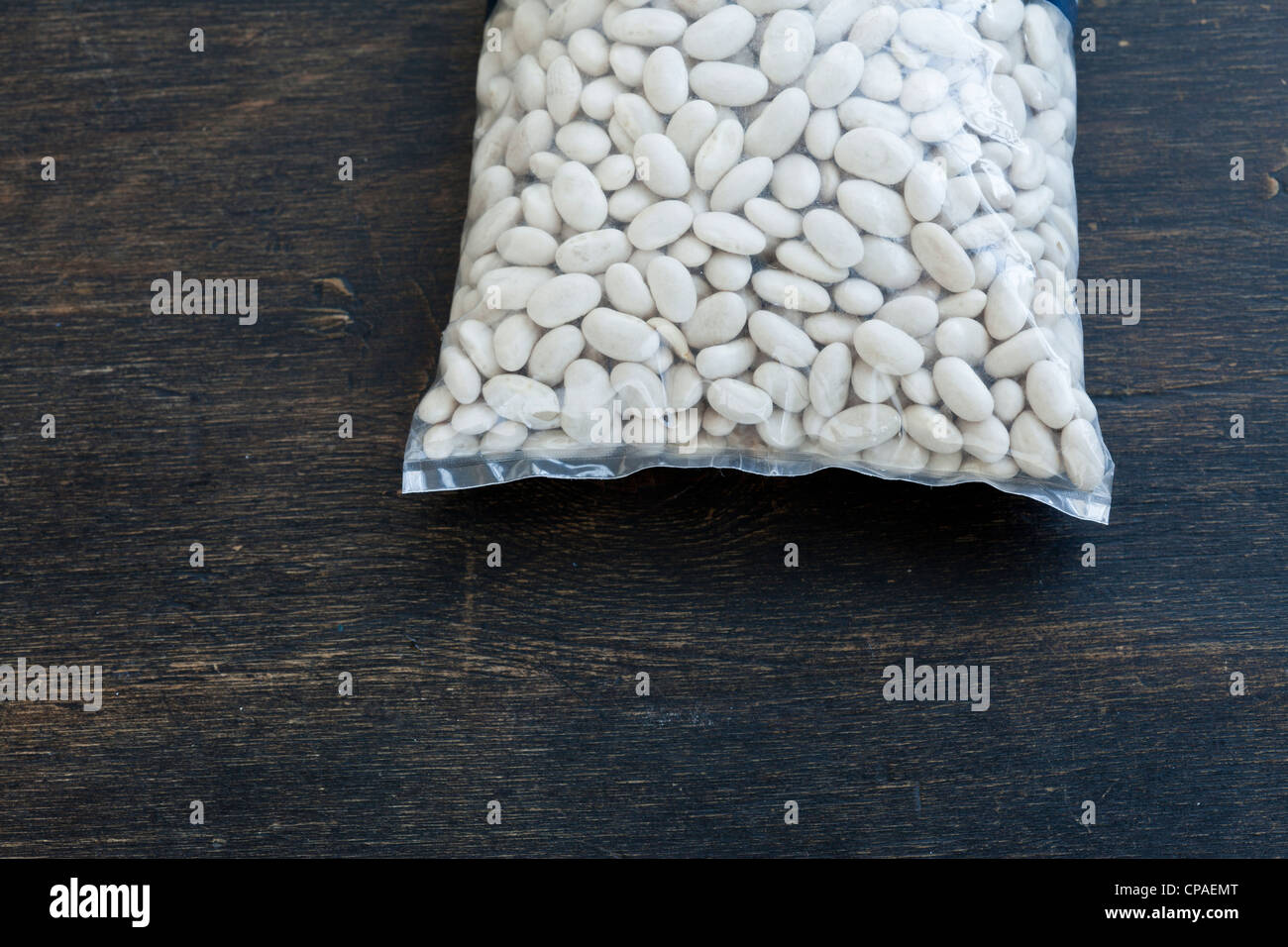 plastic bag of dry beans on wood table Stock Photo - Alamy