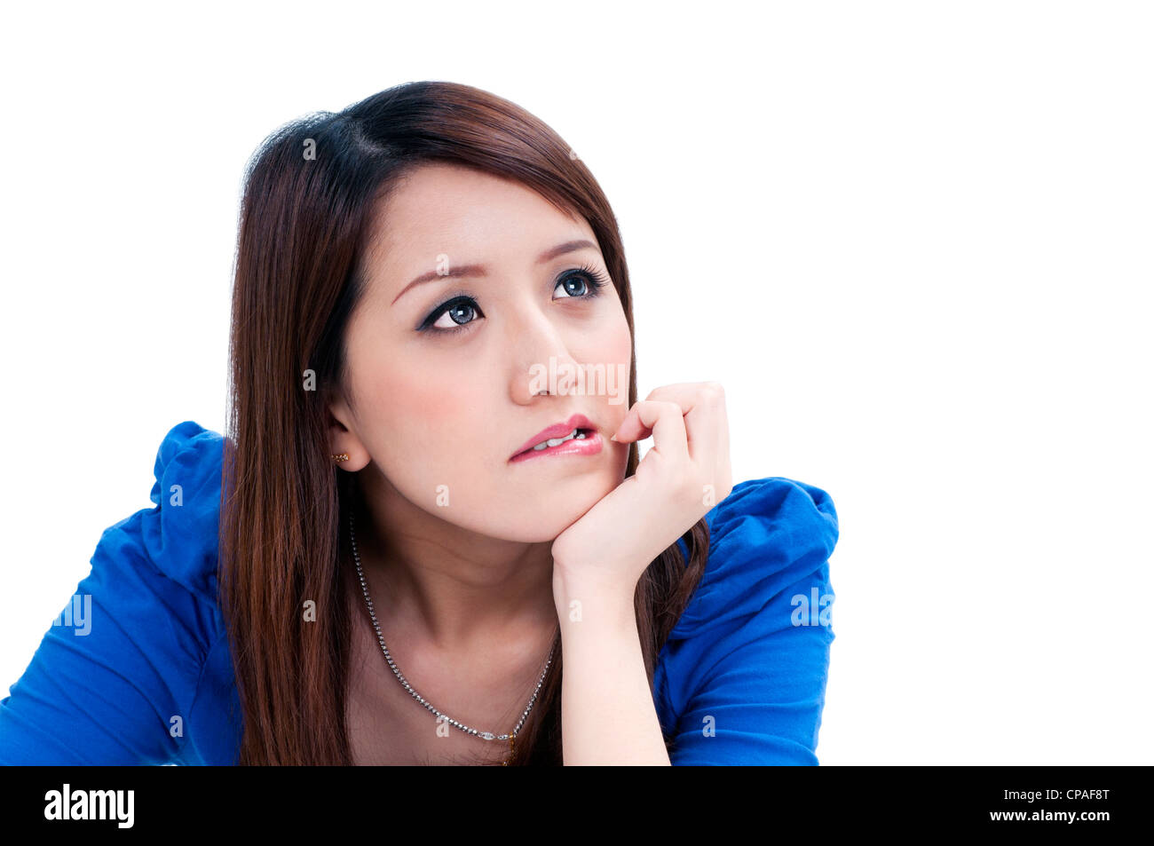 Young woman biting lips Stock Photo - Alamy