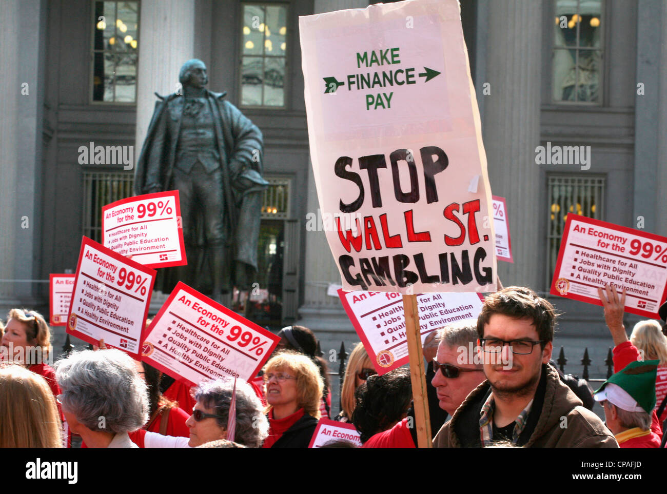 A protester in front of the Treasury Department headquarters at an ...