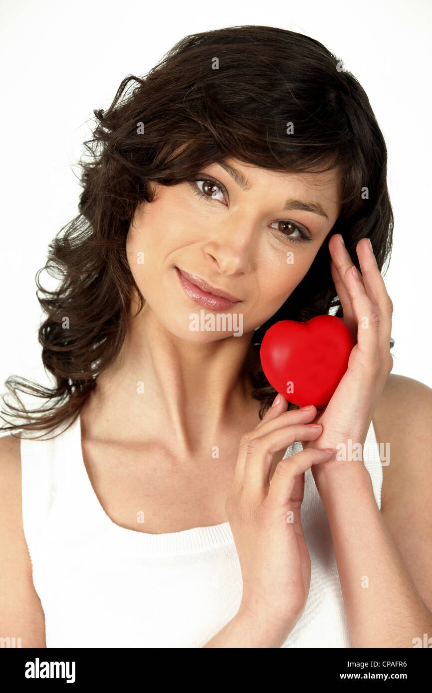 Brunette woman with heart in hand Stock Photo - Alamy