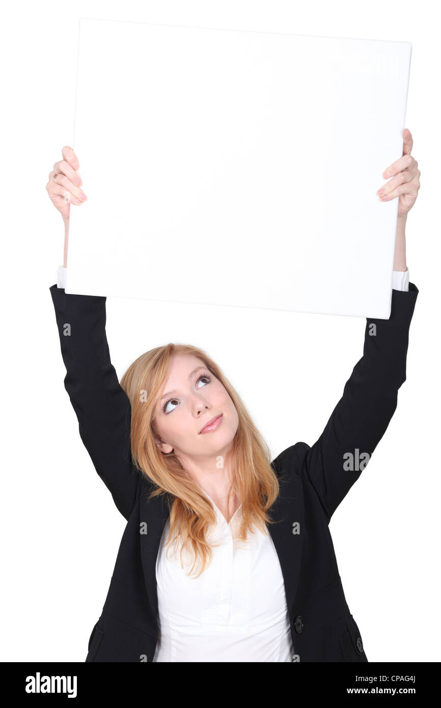 Red-haired woman raising white panel Stock Photo - Alamy