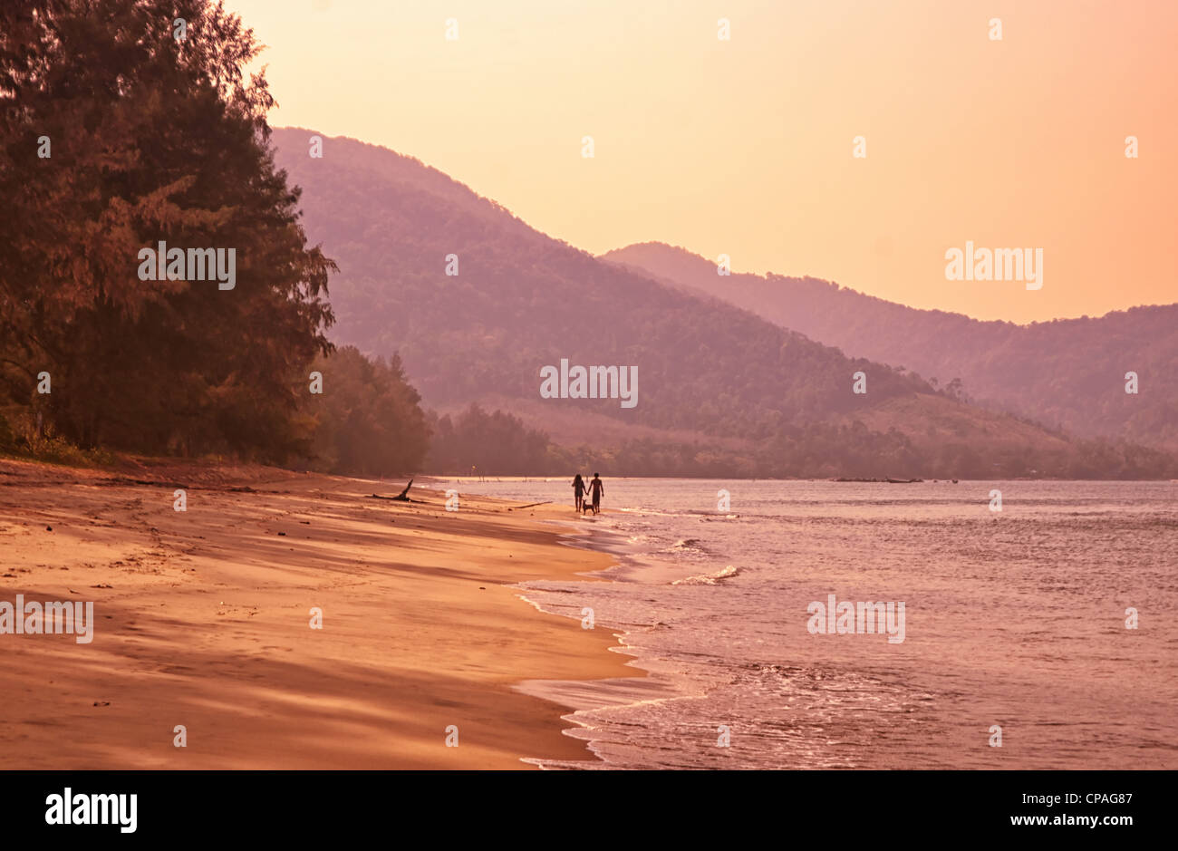 a couple walk along this tropical island beach Stock Photo - Alamy