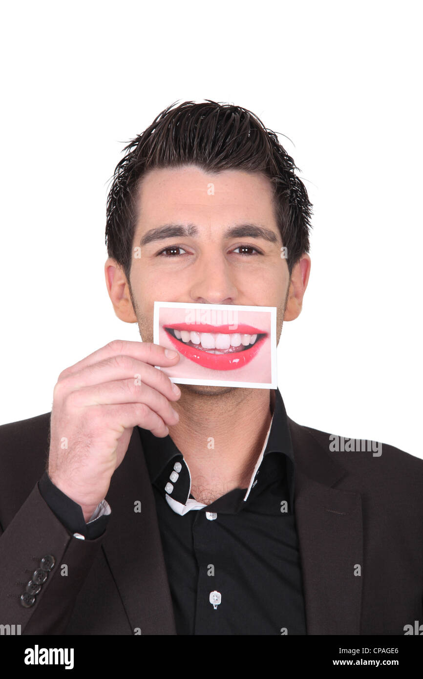 Man holding photograph of lips Stock Photo - Alamy