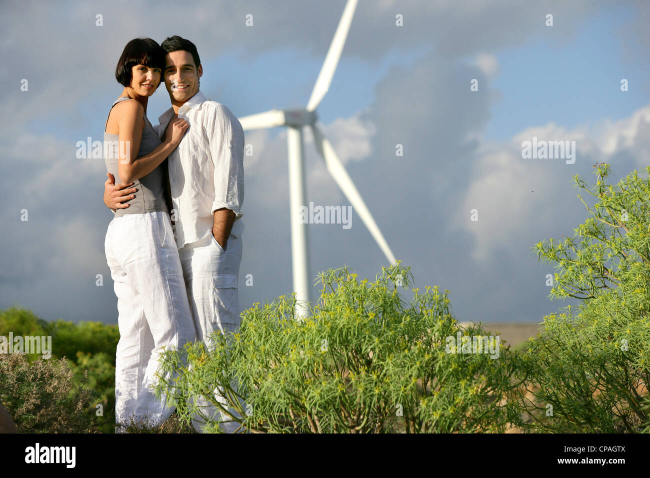 Couple stood by wind farm Stock Photo - Alamy