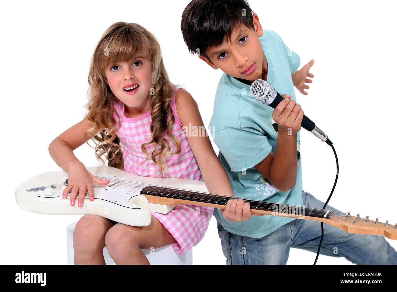 Kids pretending to be in a rock band Stock Photo - Alamy