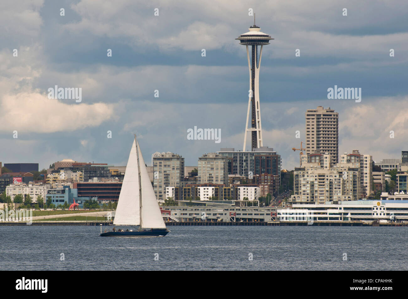 US, WA, Seattle. Sailboat in Elliott Bay crosses in front of Waterfront ...