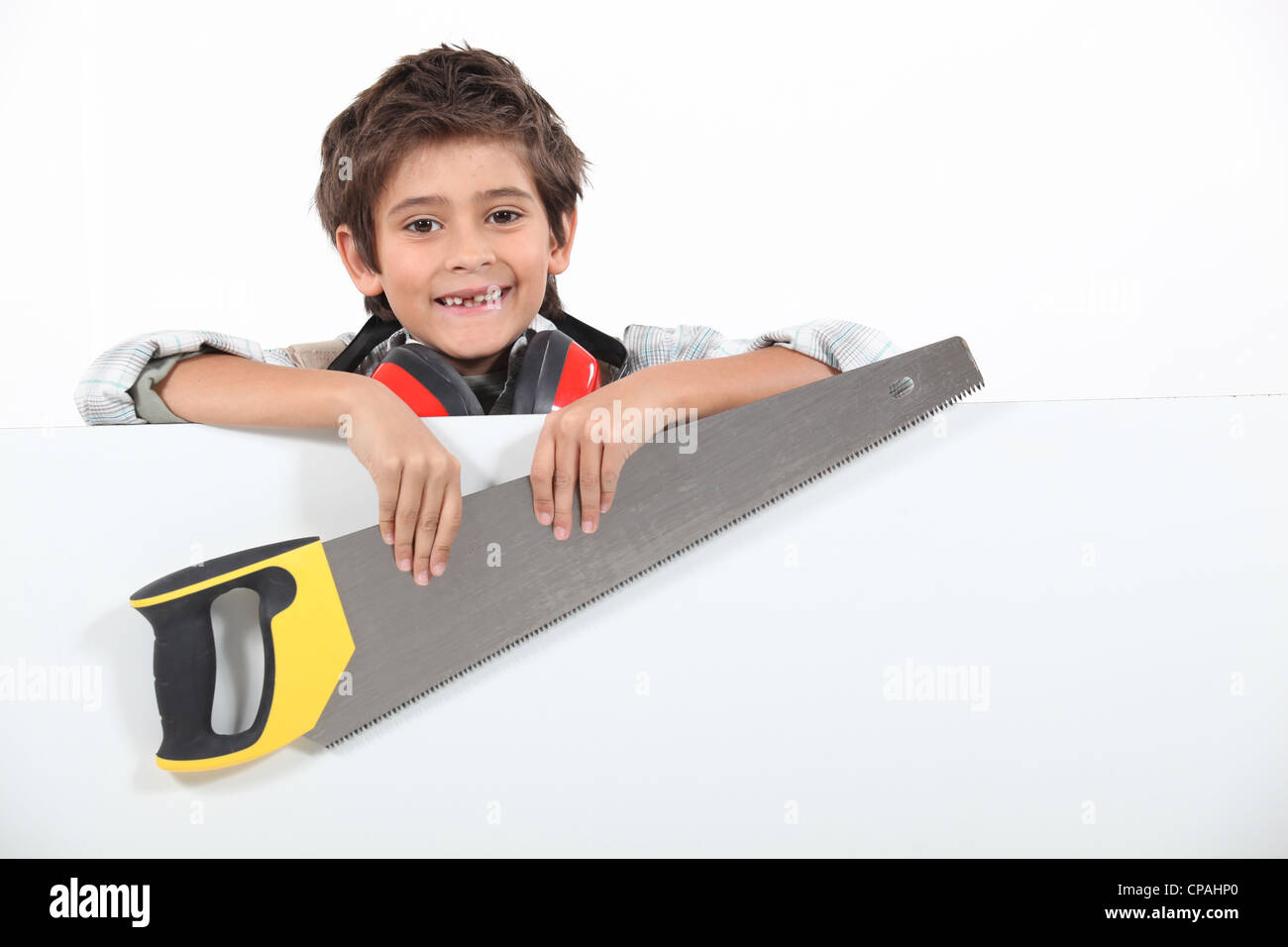 Little boy holding a saw on white background Stock Photo - Alamy