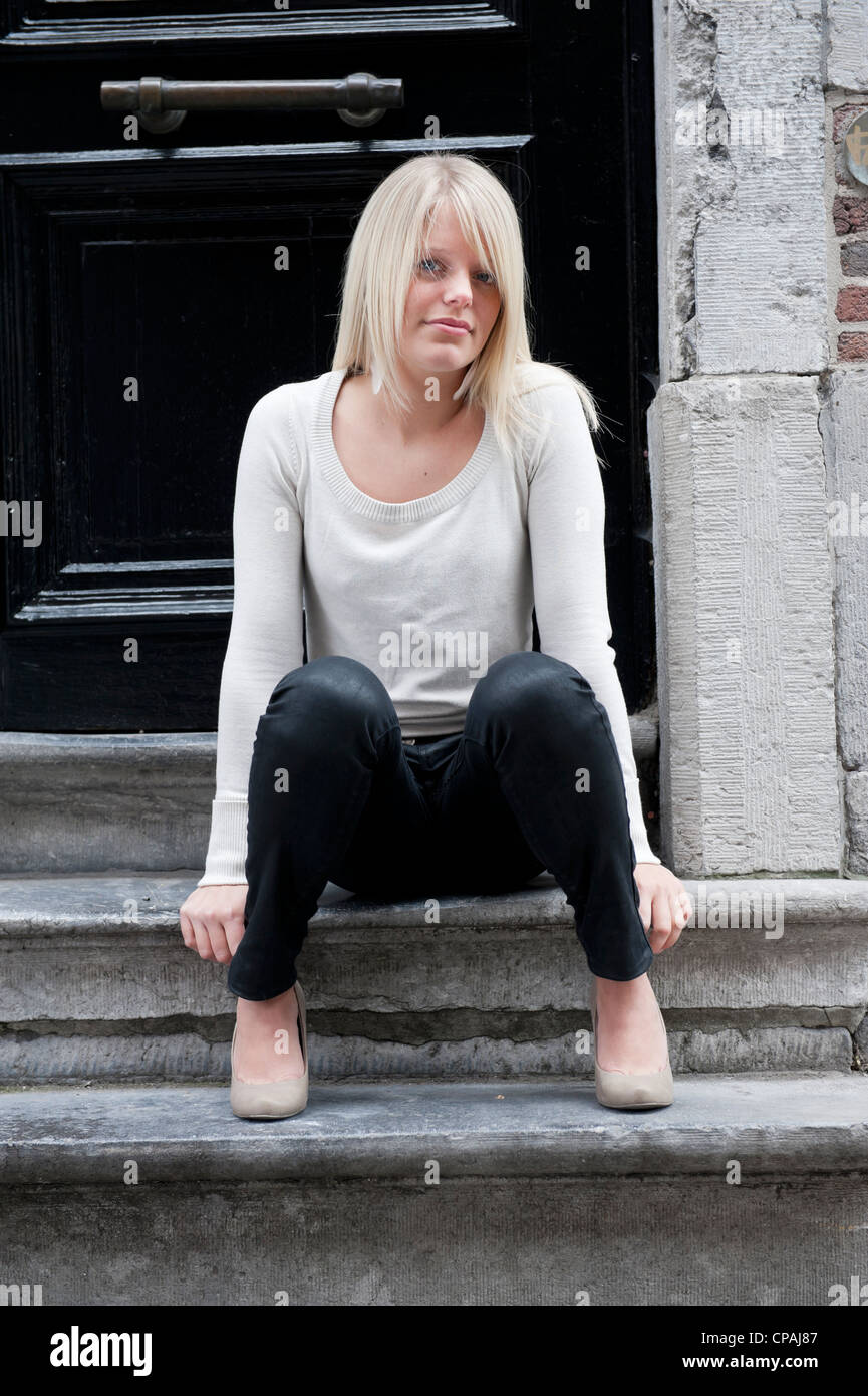 Woman seated on stairs hi-res stock photography and images - Alamy