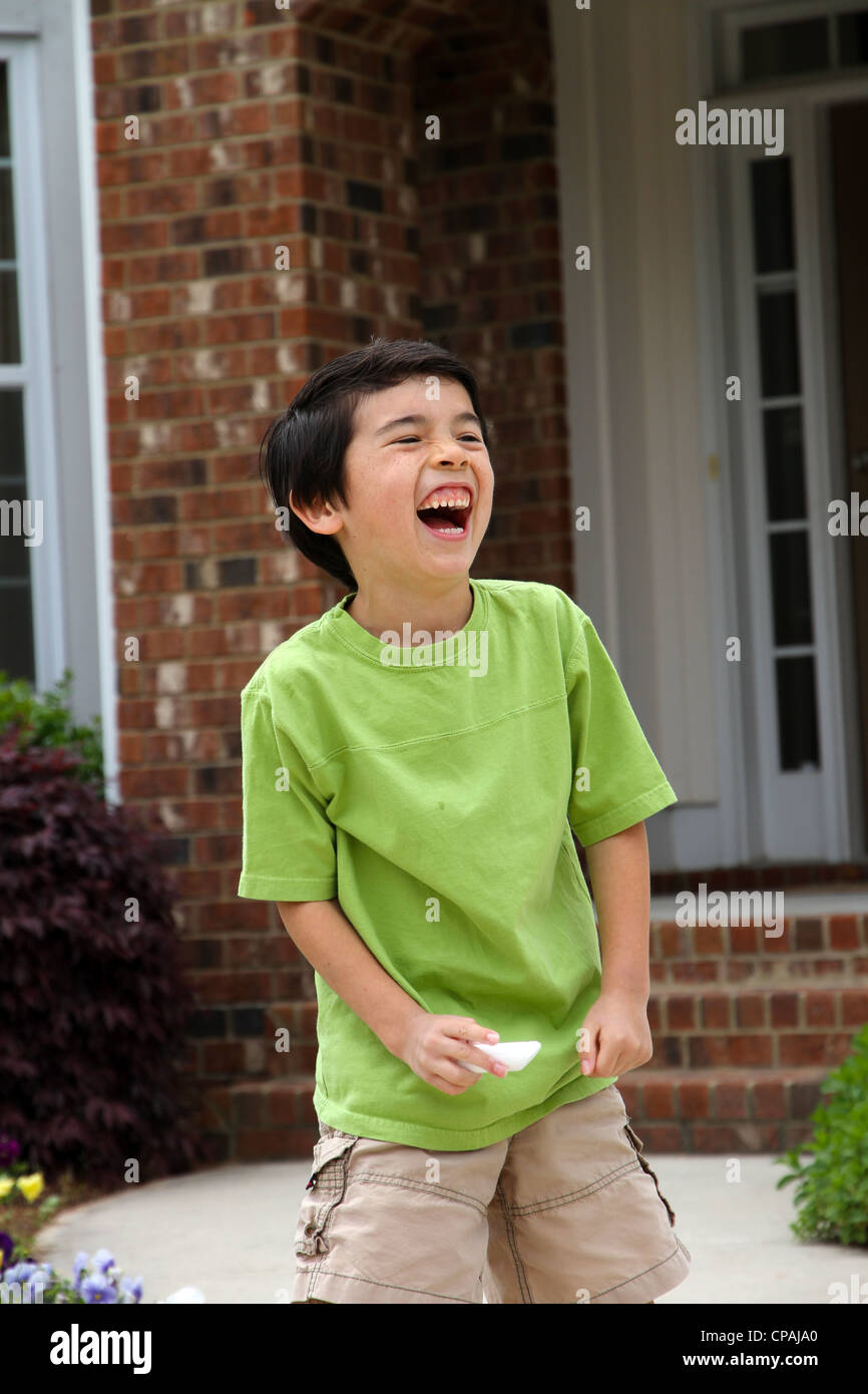 Child playing with chalk in the driveway Stock Photo - Alamy