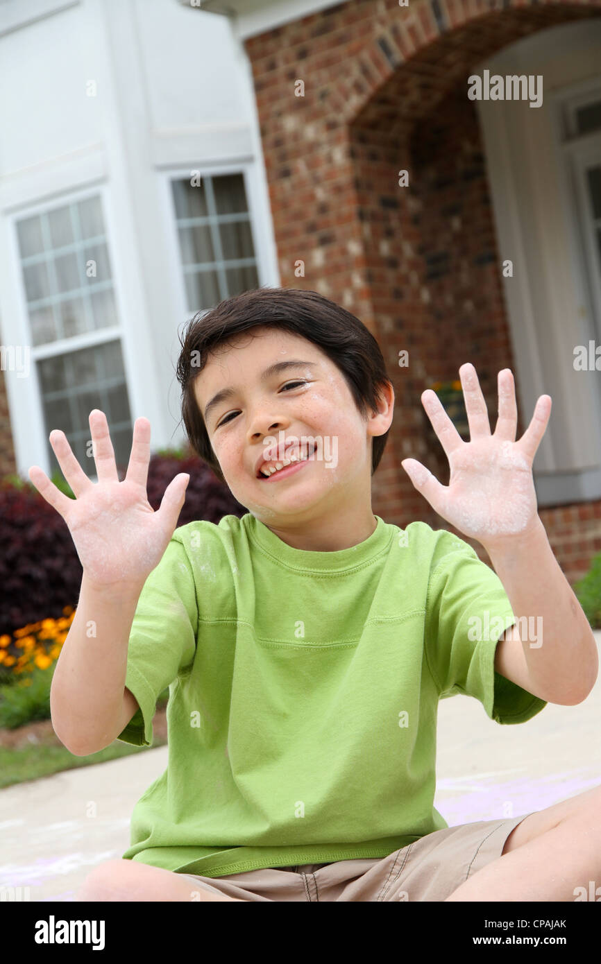 Child playing with chalk in the driveway Stock Photo - Alamy