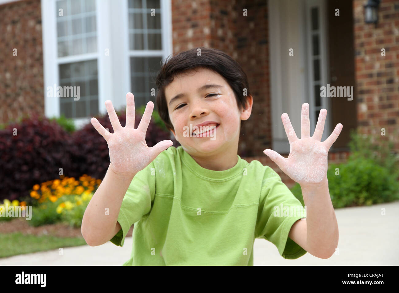 Child playing with chalk in the driveway Stock Photo - Alamy