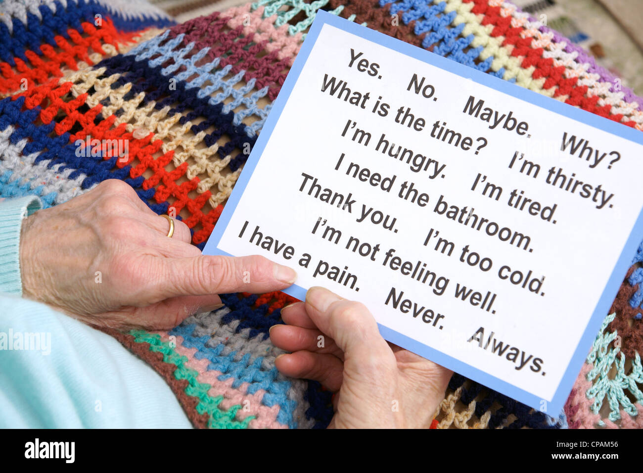 Elderly woman using a communication card suffering from pain (cared for ...