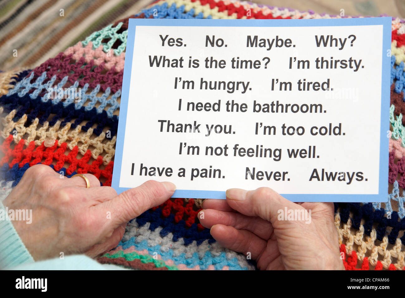 Elderly woman using a communication card suffering from pain (cared for ...