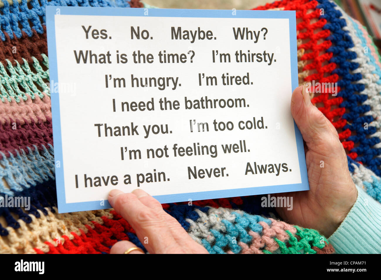Elderly woman using a communication card suffering from pain (cared for ...