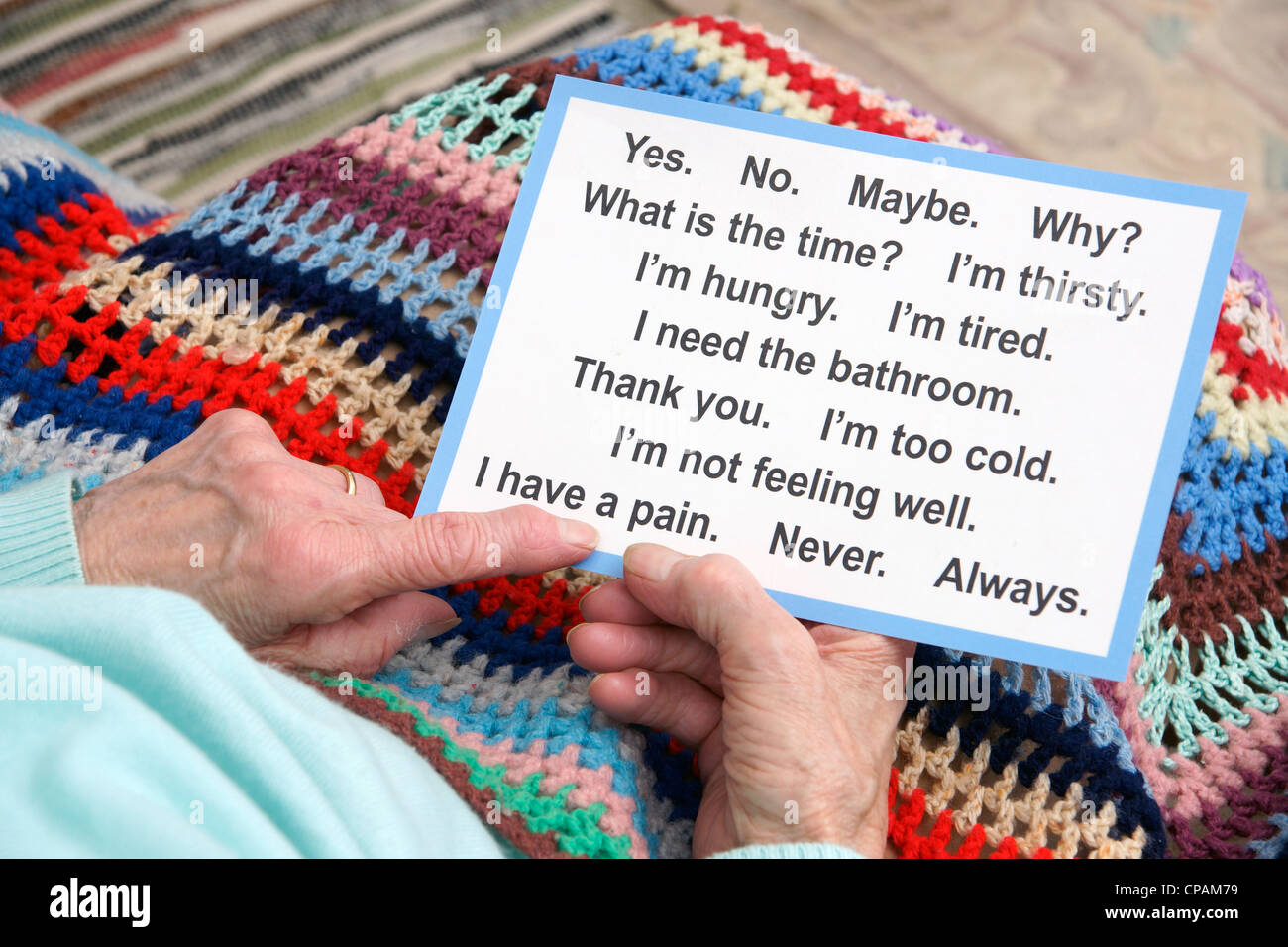 Elderly woman using a communication card suffering from pain (cared for ...