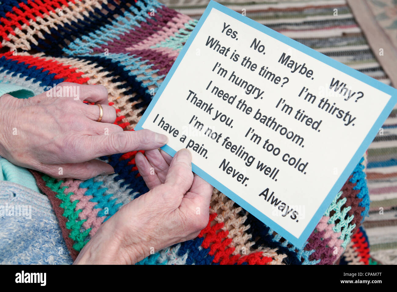 Elderly woman using a communication card suffering from pain (cared for ...