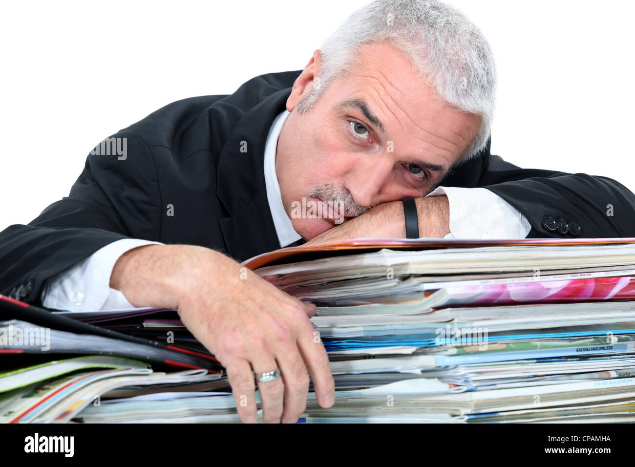 Man lying on paperwork Stock Photo - Alamy