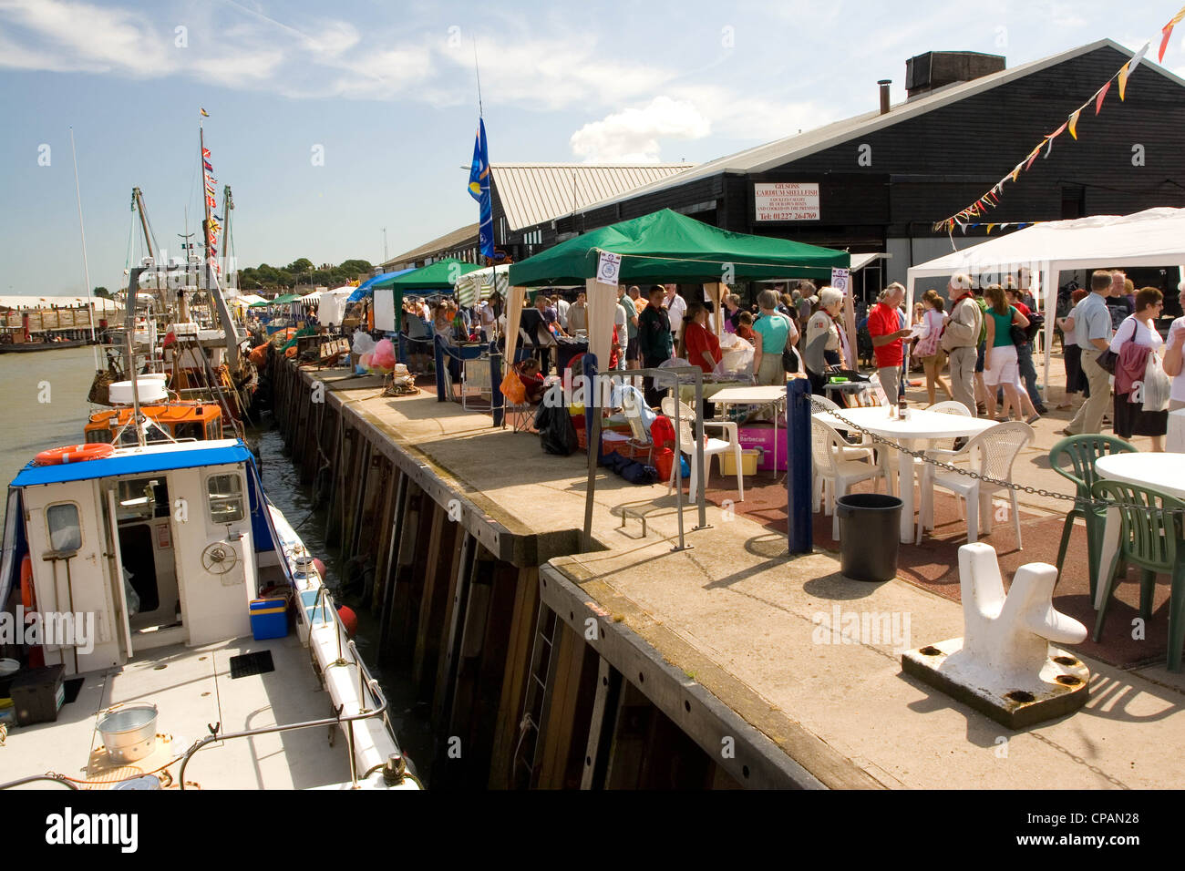 Boats and visitors in Whitstable Harbour, Kent, England, UK Stock Photo ...