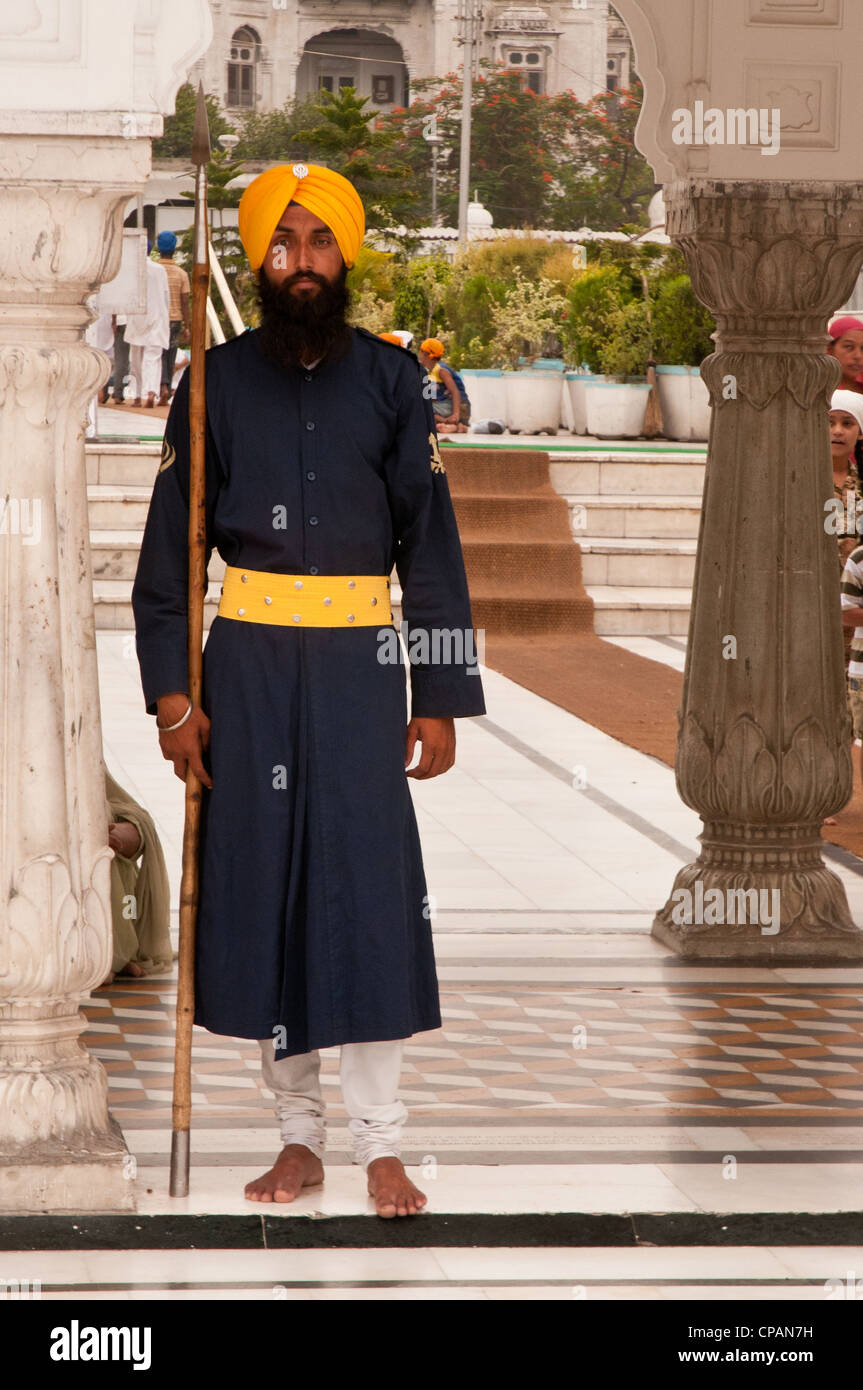 Sikh guard stands in an arch way at the Golden Temple in Amritsar ...