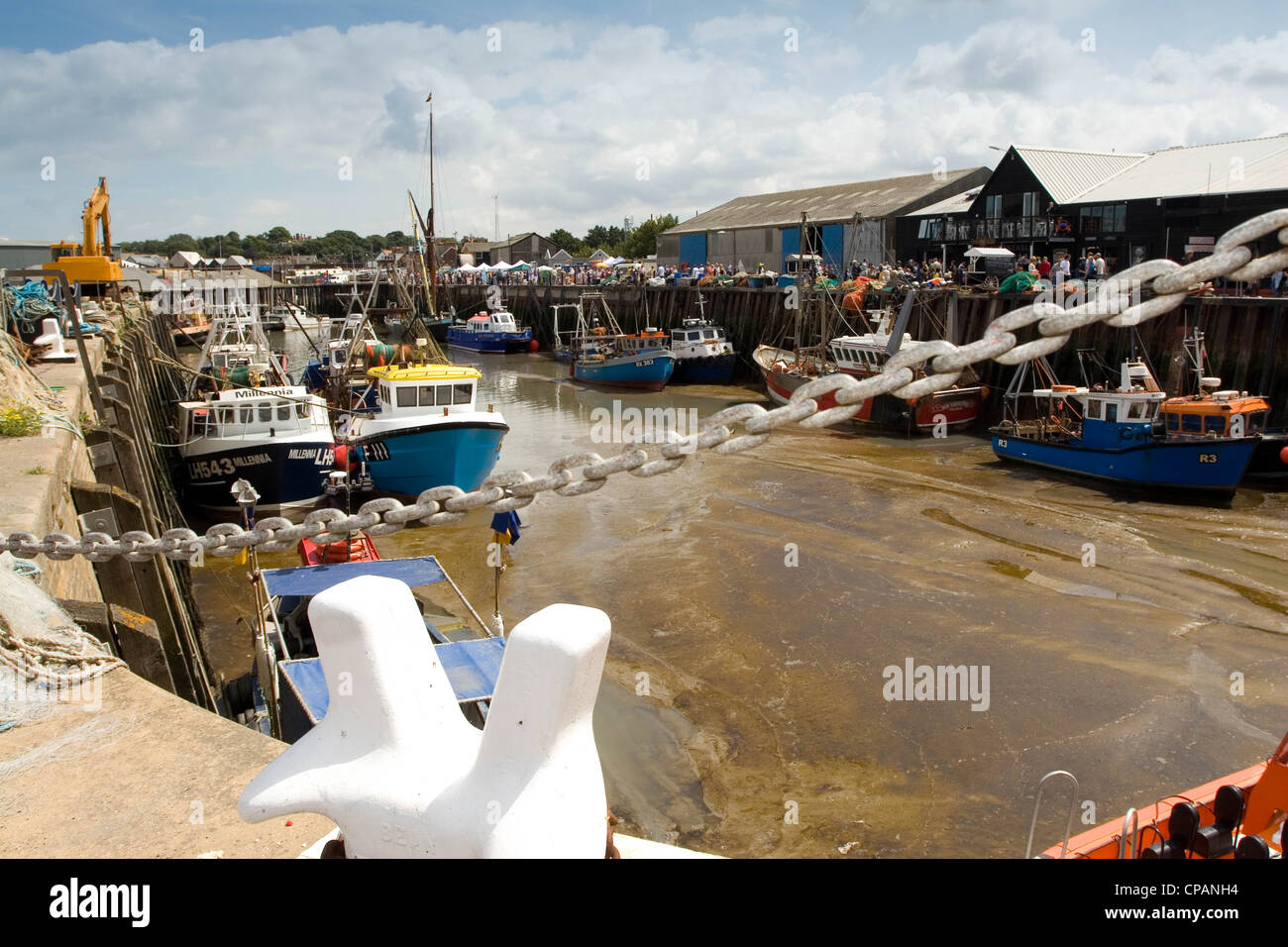 Boats at low tide in Whitstable Harbour and fish market in Kent ...