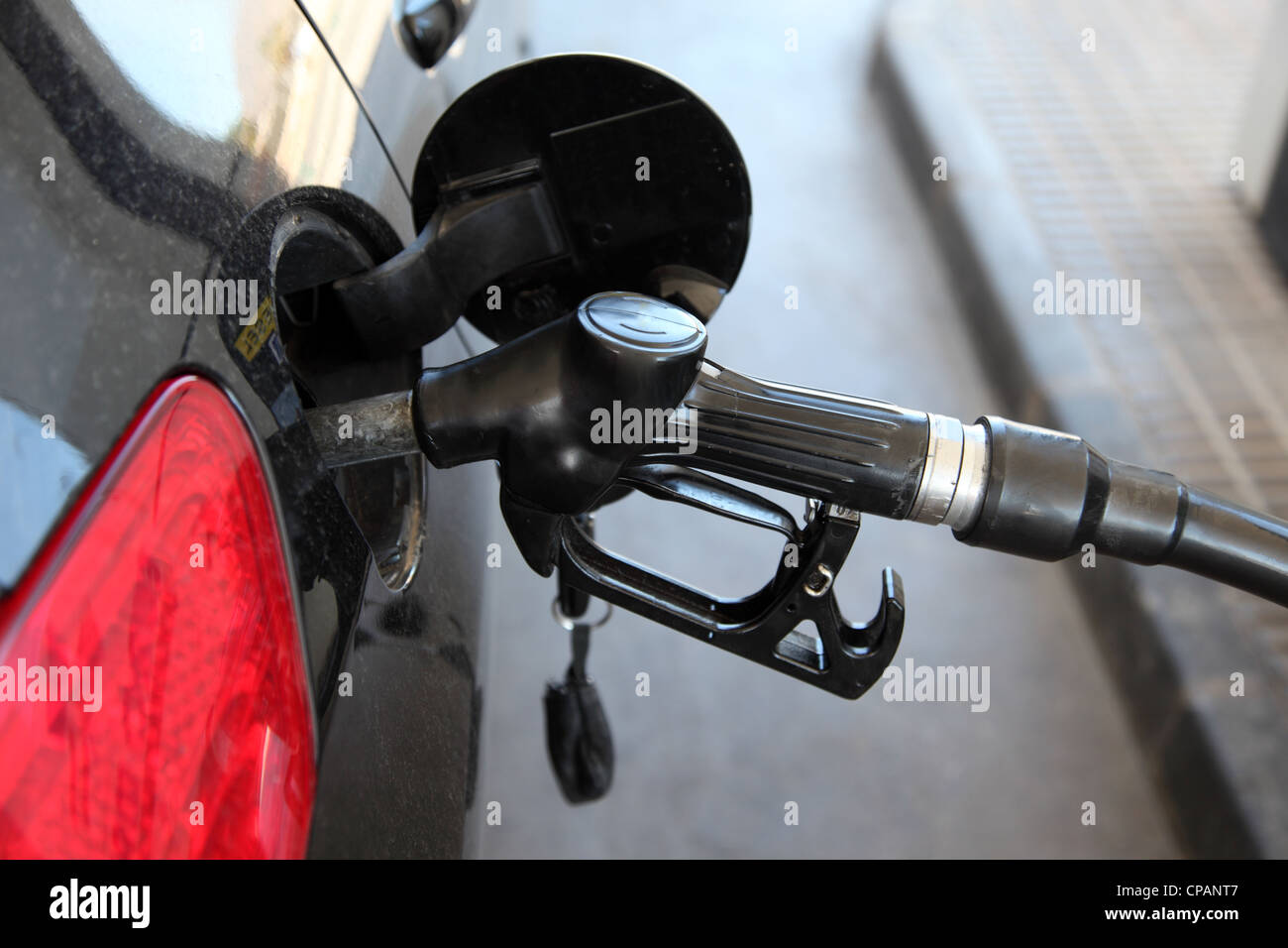 Gas station pump nozzle in the cars fuel tank Stock Photo - Alamy