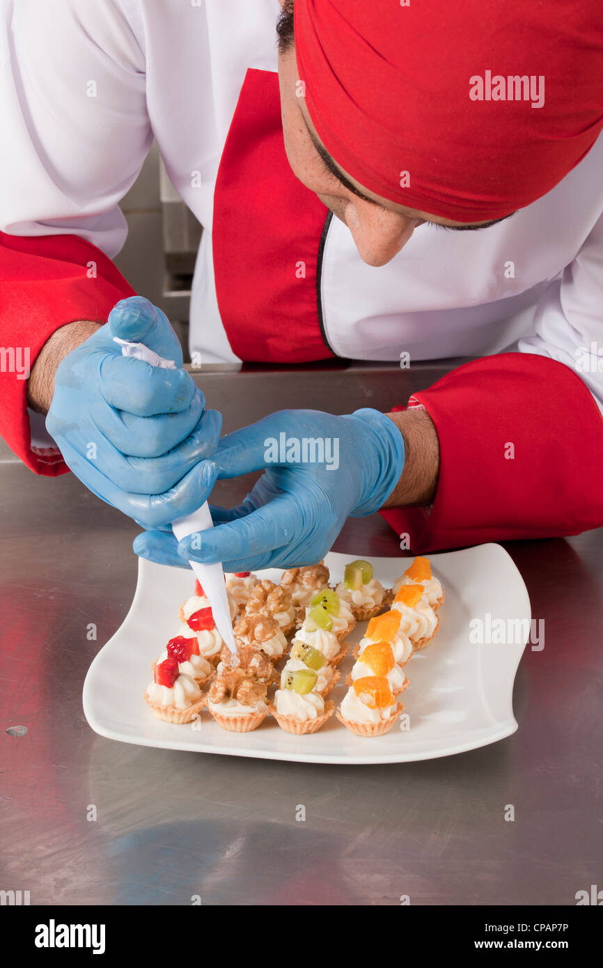 chef garnishing canapes Stock Photo - Alamy