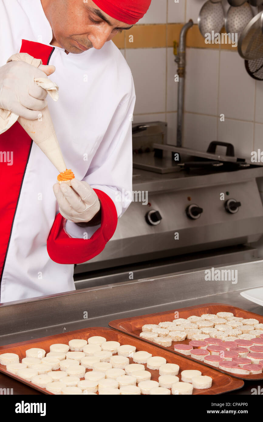chef garnishing canapes Stock Photo - Alamy