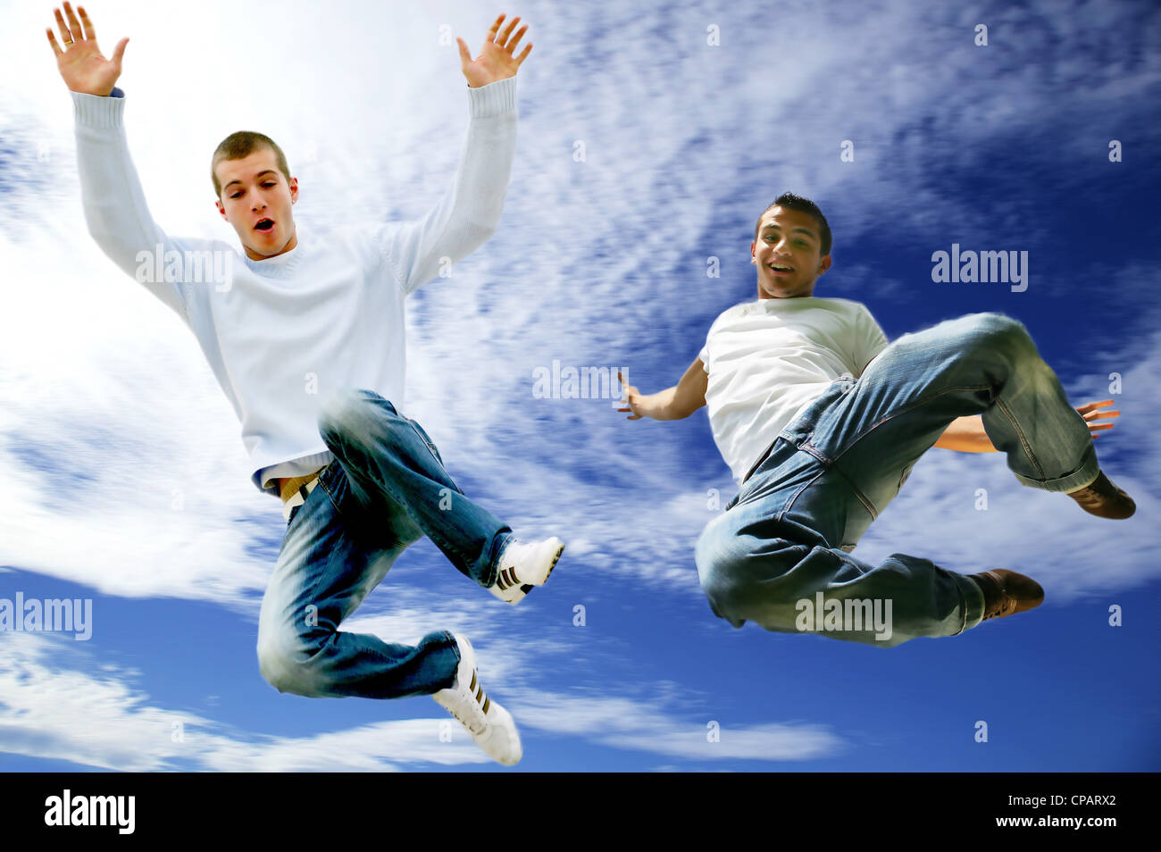 Two young men jumping in the air Stock Photo - Alamy