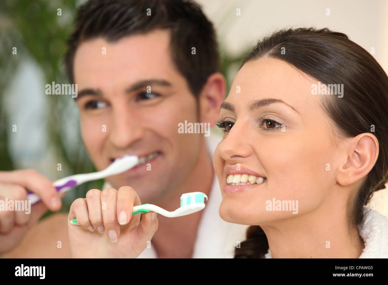 Couple brushing their teeth Stock Photo - Alamy