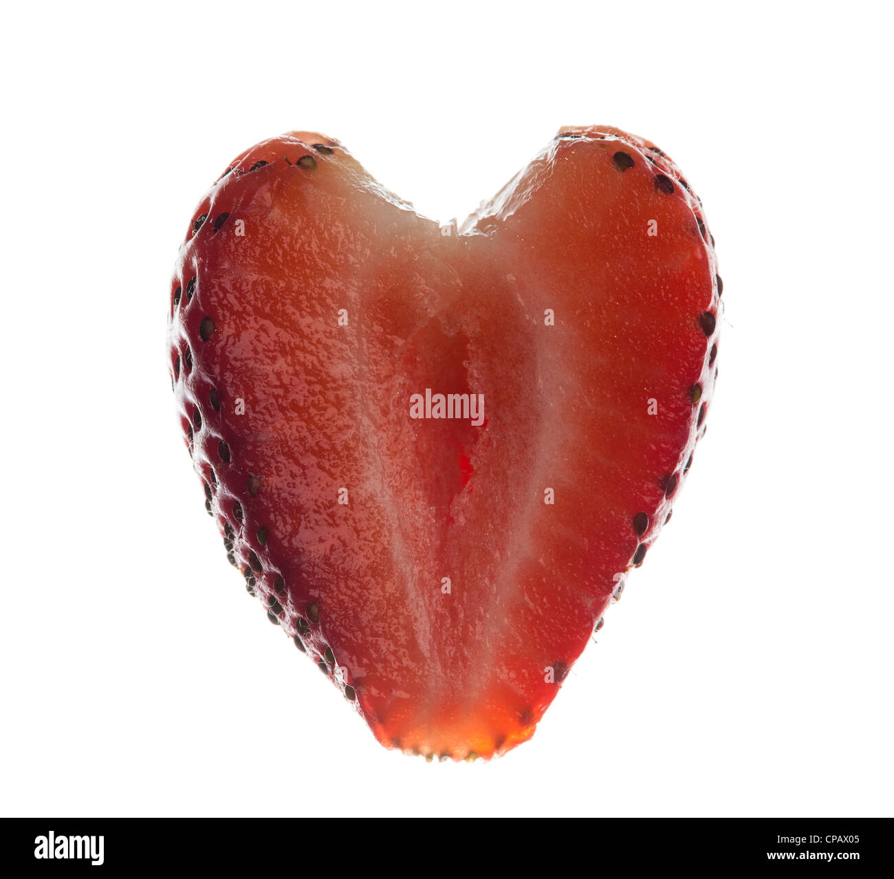 Freshly sliced strawberry in shape of heart isolated against white ...