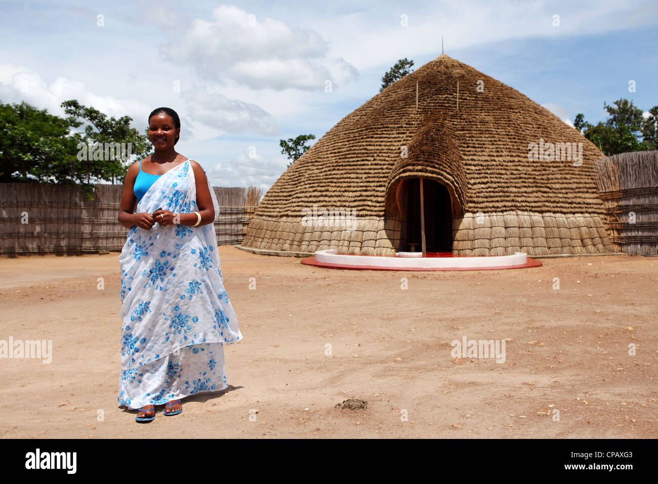 Justine, a guide, shows off a hut at the King's Palace, Nyanza, Rwanda ...