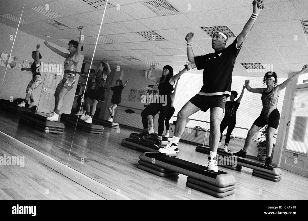 A step class in a gym with a single male participant Stock Photo - Alamy