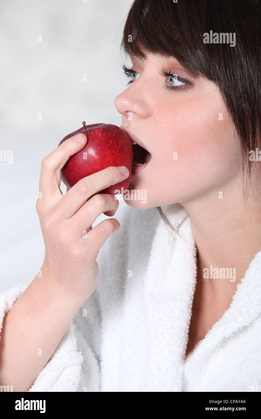 Woman biting into delicious red apple Stock Photo - Alamy