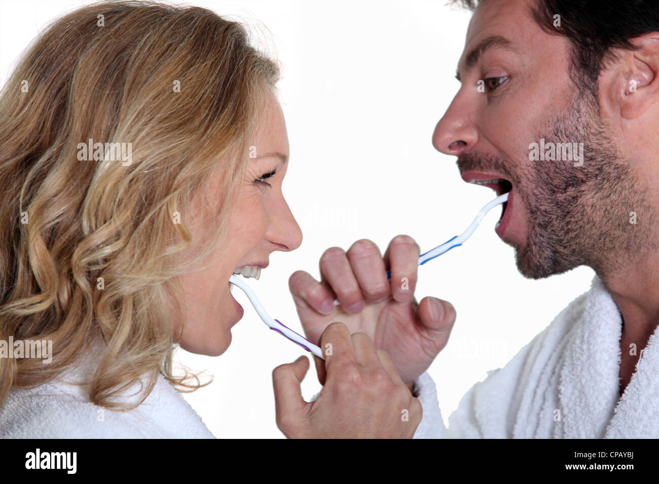 Couple brushing teeth Stock Photo - Alamy
