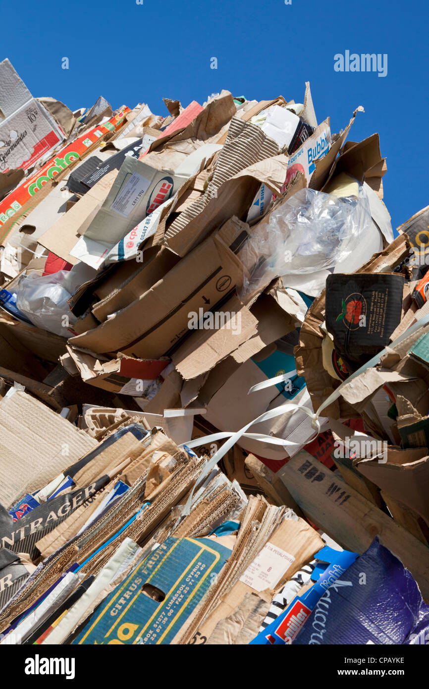 waste paper and cardboard stacked for recycling ready for collection ...