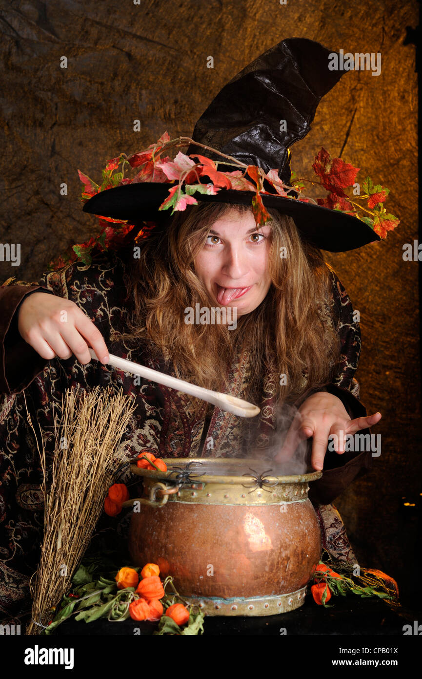 halloween witch cooking in a copper, making faces Stock Photo - Alamy