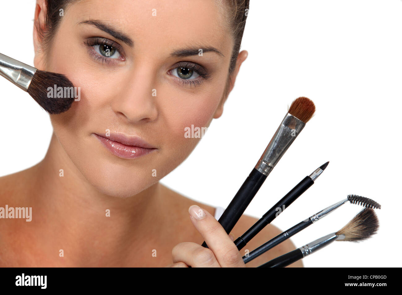 Woman posing with her make-up brushes Stock Photo - Alamy