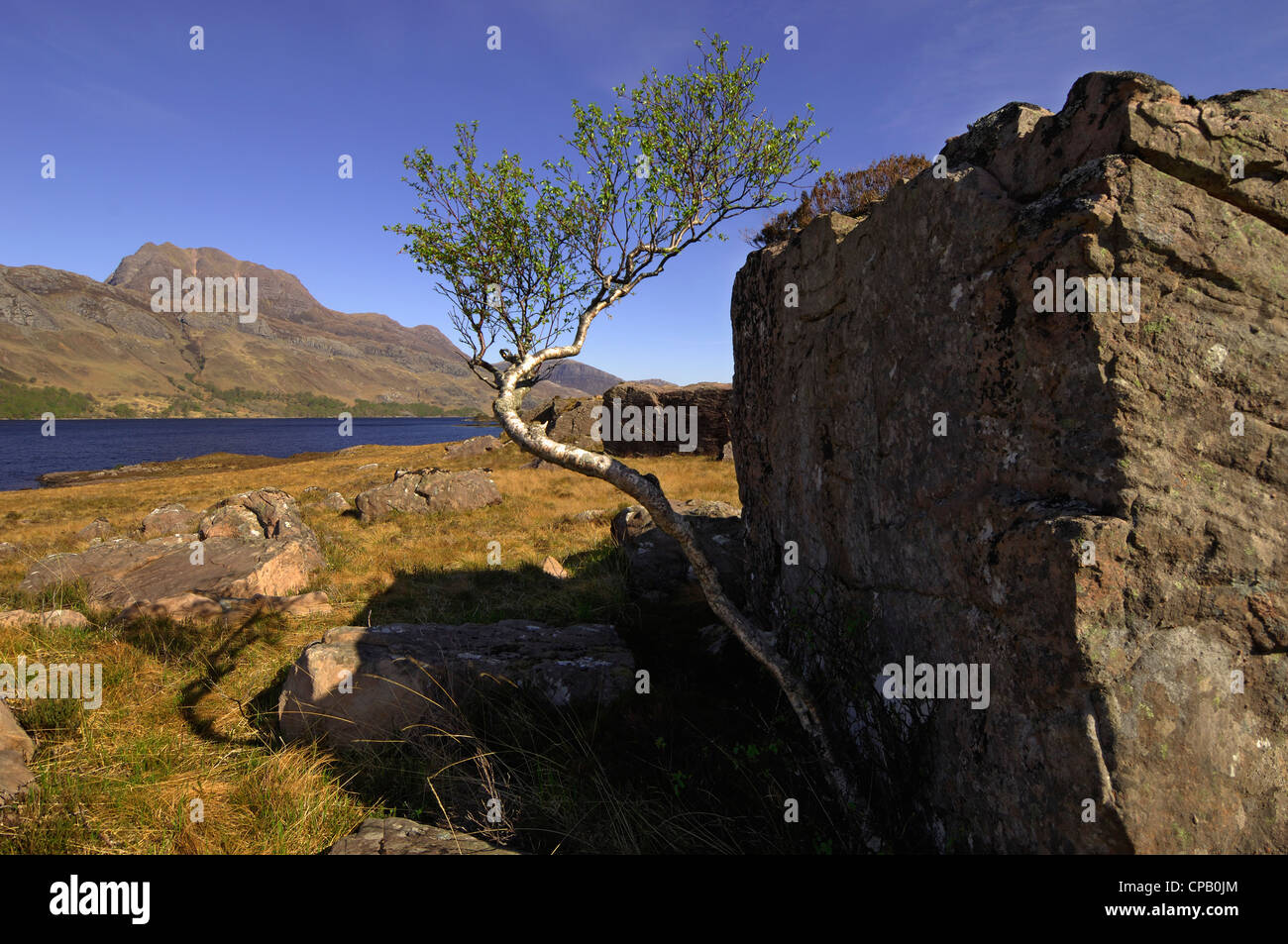 Big square boulder and distant mountain - Slioch, seen across Loch ...