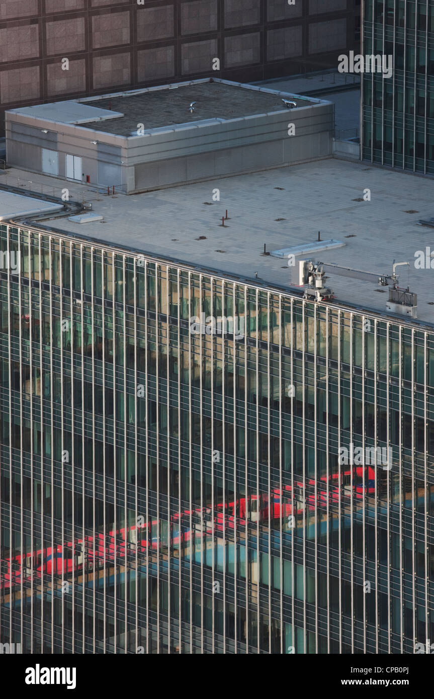 Reflection of tube train in office building, Canary Wharf; London ...
