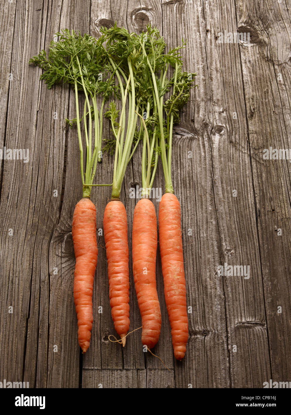 Four carrot on wood hi-res stock photography and images - Alamy