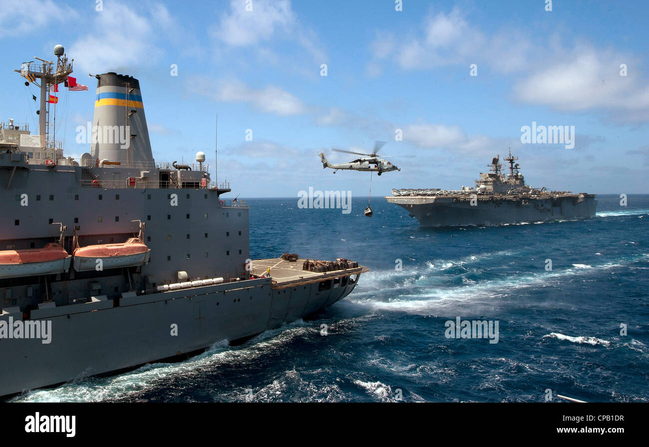 An MH-60S Sea Hawk helicopter delivers cargo to the amphibious assault ...