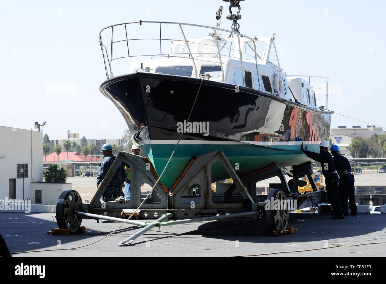 U.S. sailors and contractors aboard the aircraft carrier USS Nimitz ...