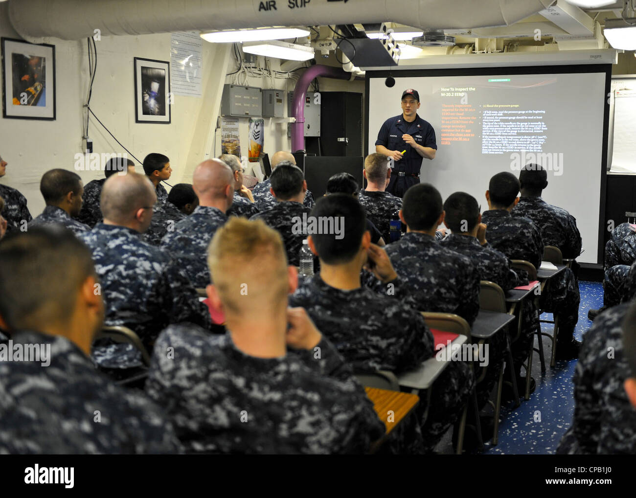 Damage Controlman 2nd Class Stuart Hooper teaches a basic damage ...