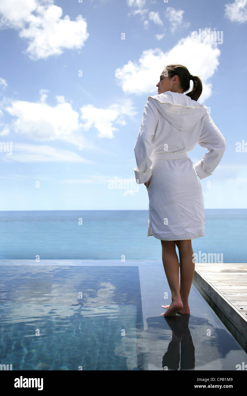 Woman stood by swimming pool in bathing robe Stock Photo - Alamy