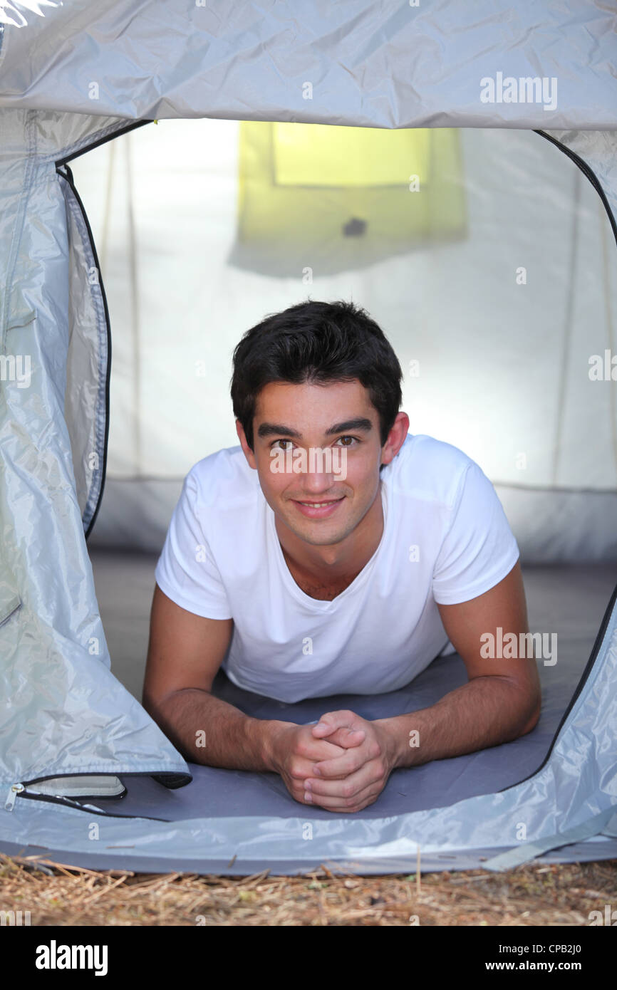 Boy lying in tent Stock Photo - Alamy