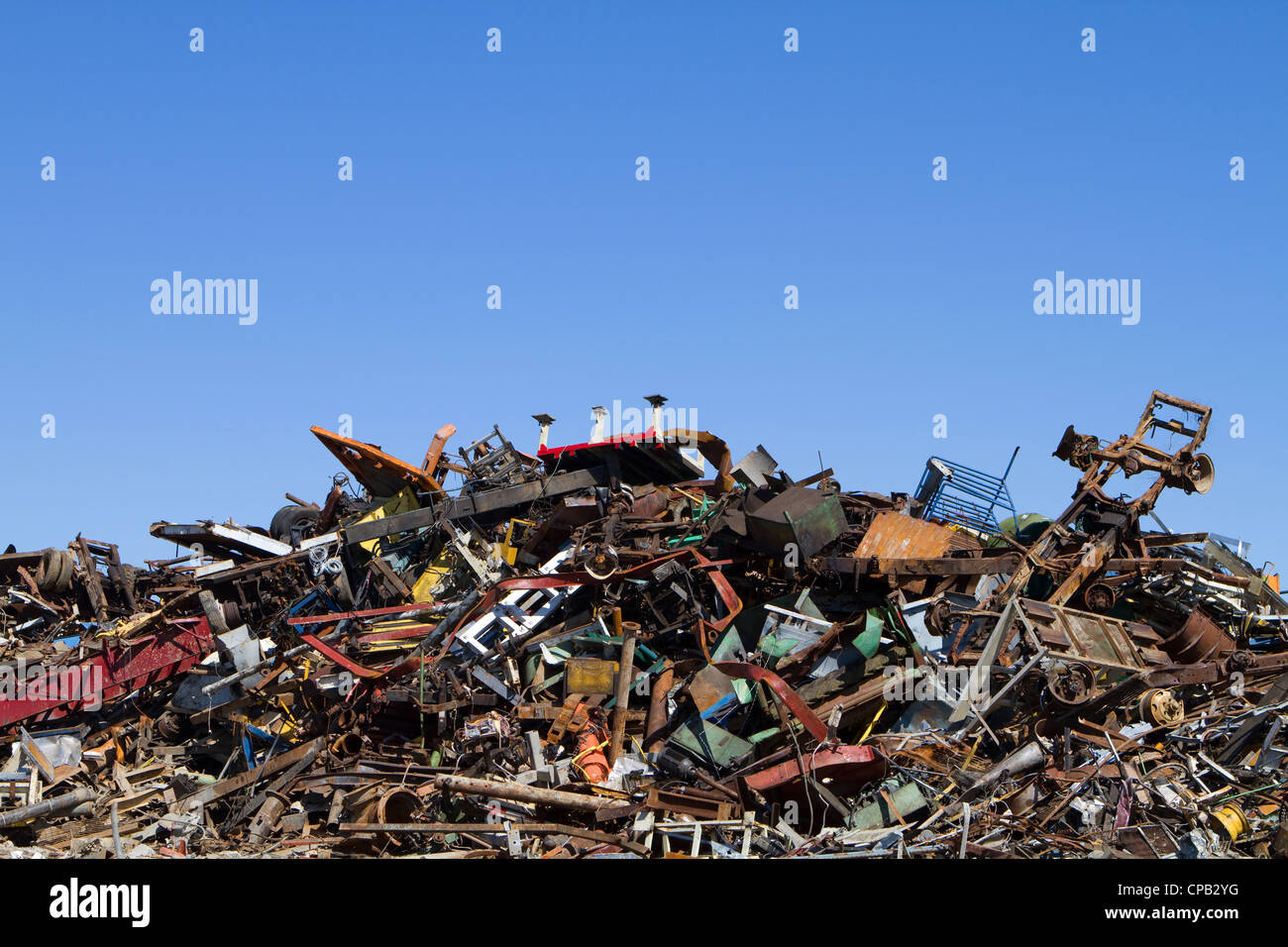 Scrap metal waste is stored in a recycling yard waiting to be melted ...