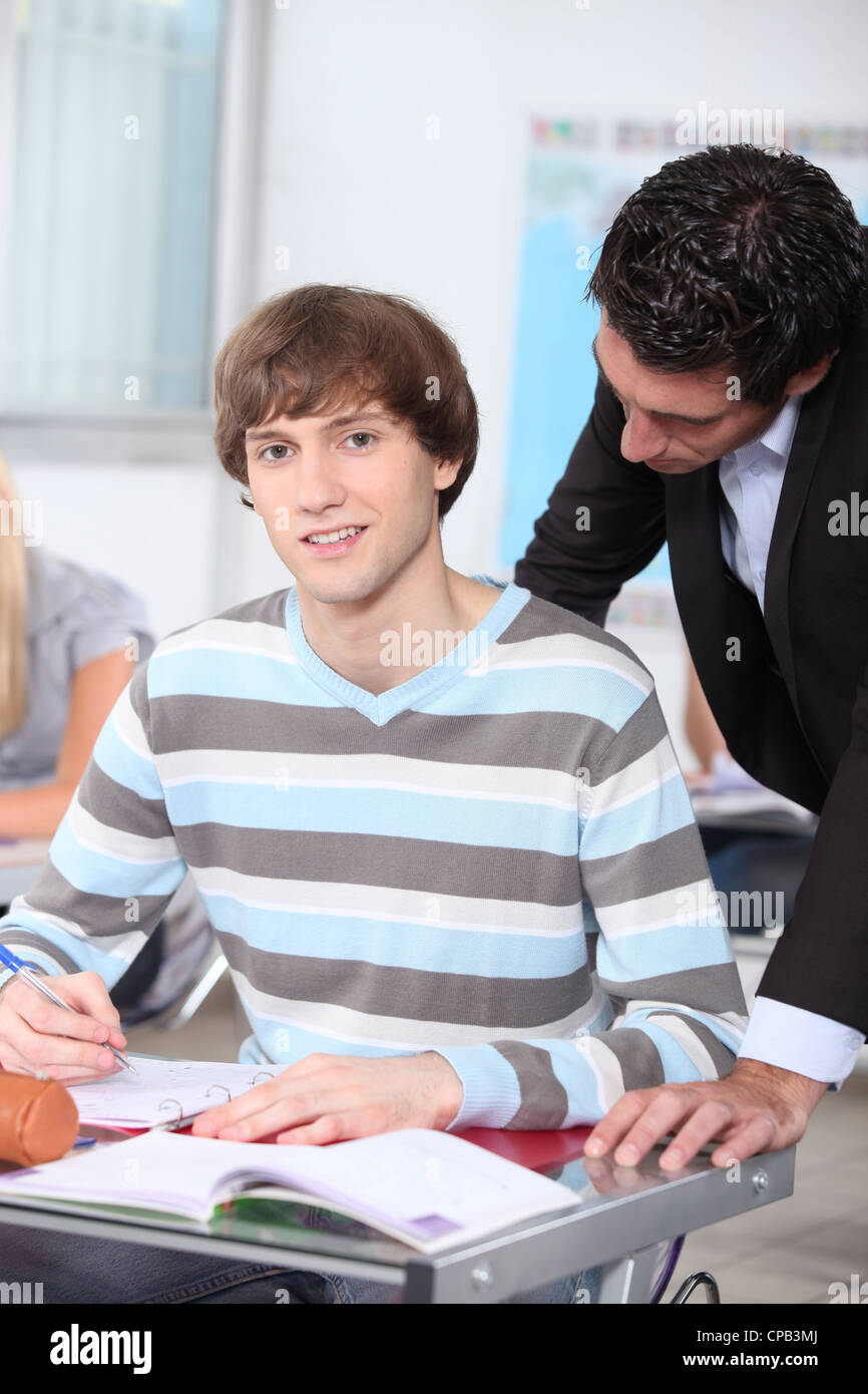 Teacher checking student's work Stock Photo - Alamy