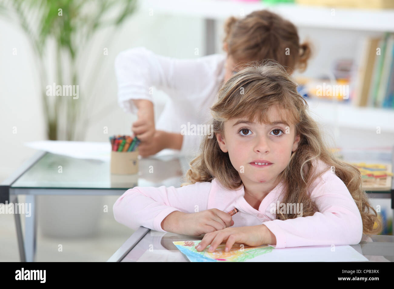 Two Young girls in class Stock Photo - Alamy